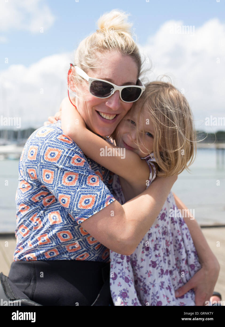 Cuddle with mum Stock Photo - Alamy