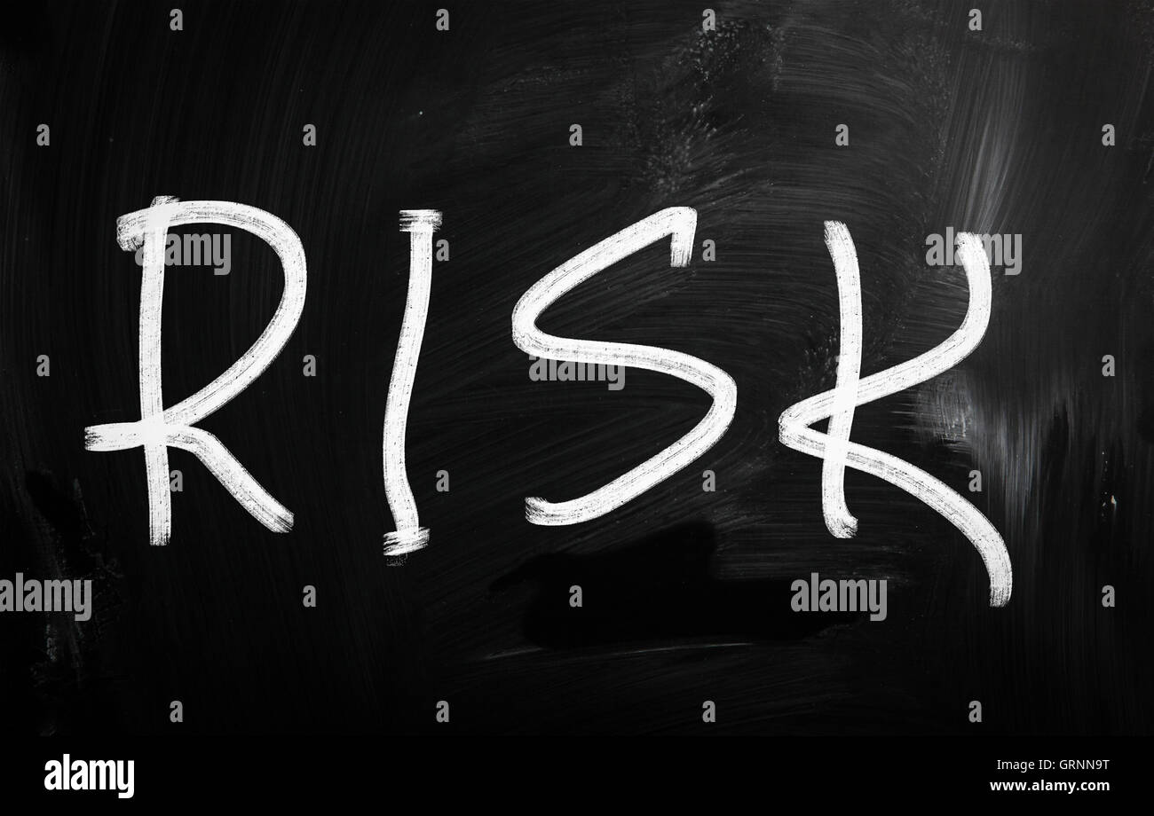 The word "Risk" handwritten with white chalk on a blackboard Stock ...