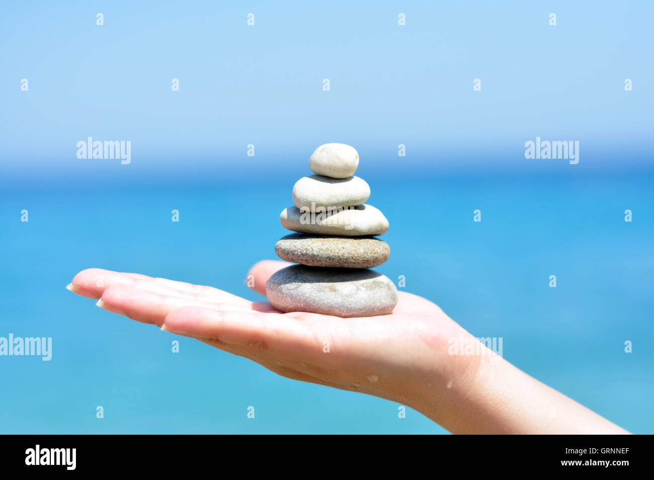 Zen stones hand Stock Photo - Alamy