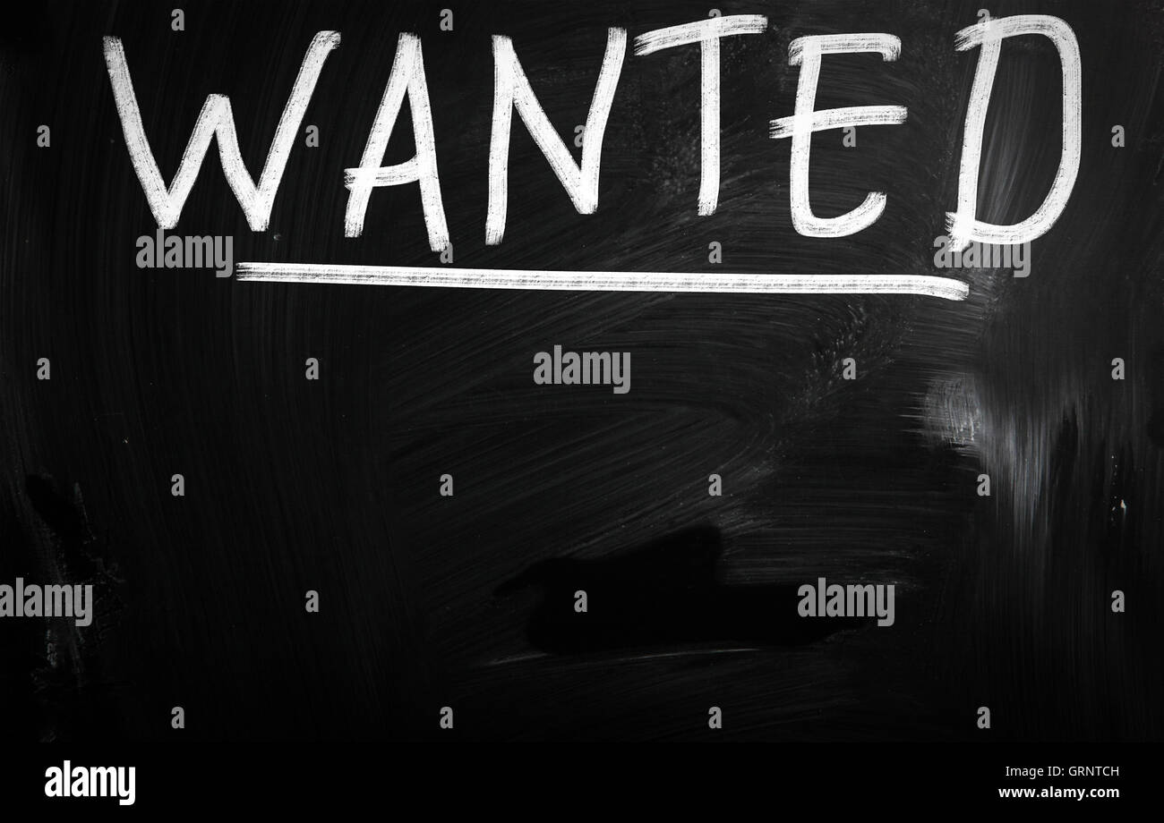 Wanted handwritten with white chalk on a blackboard Stock Photo - Alamy