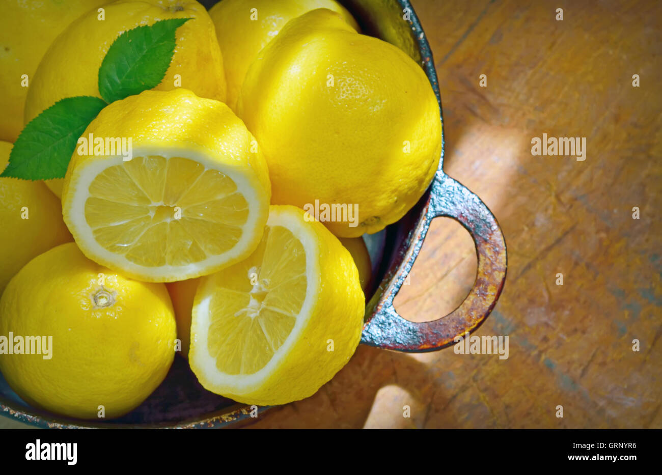 fresh lemons on a wood table Stock Photo - Alamy