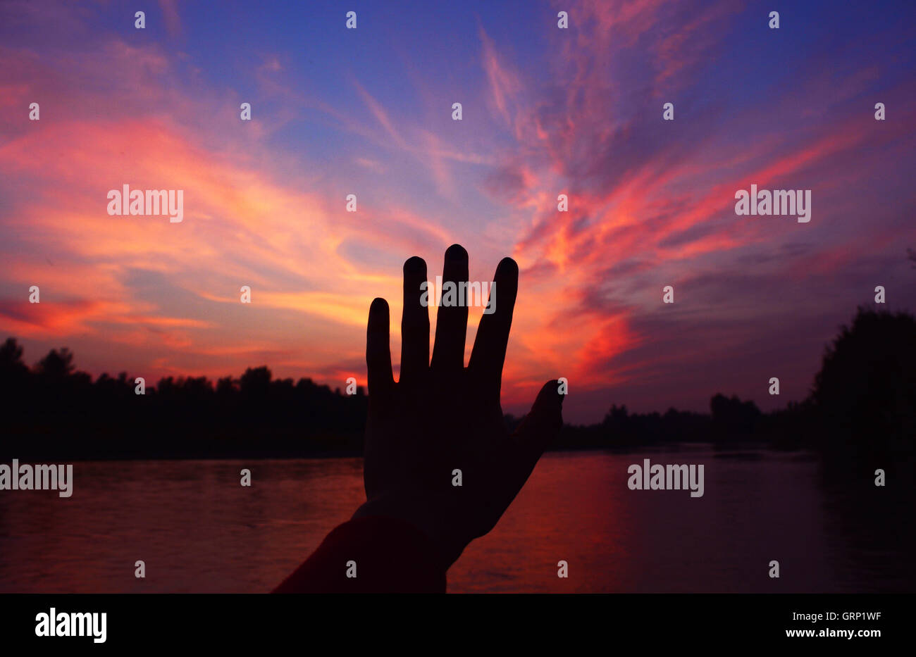 Magic sunset with colourful clouds and moon Stock Photo - Alamy