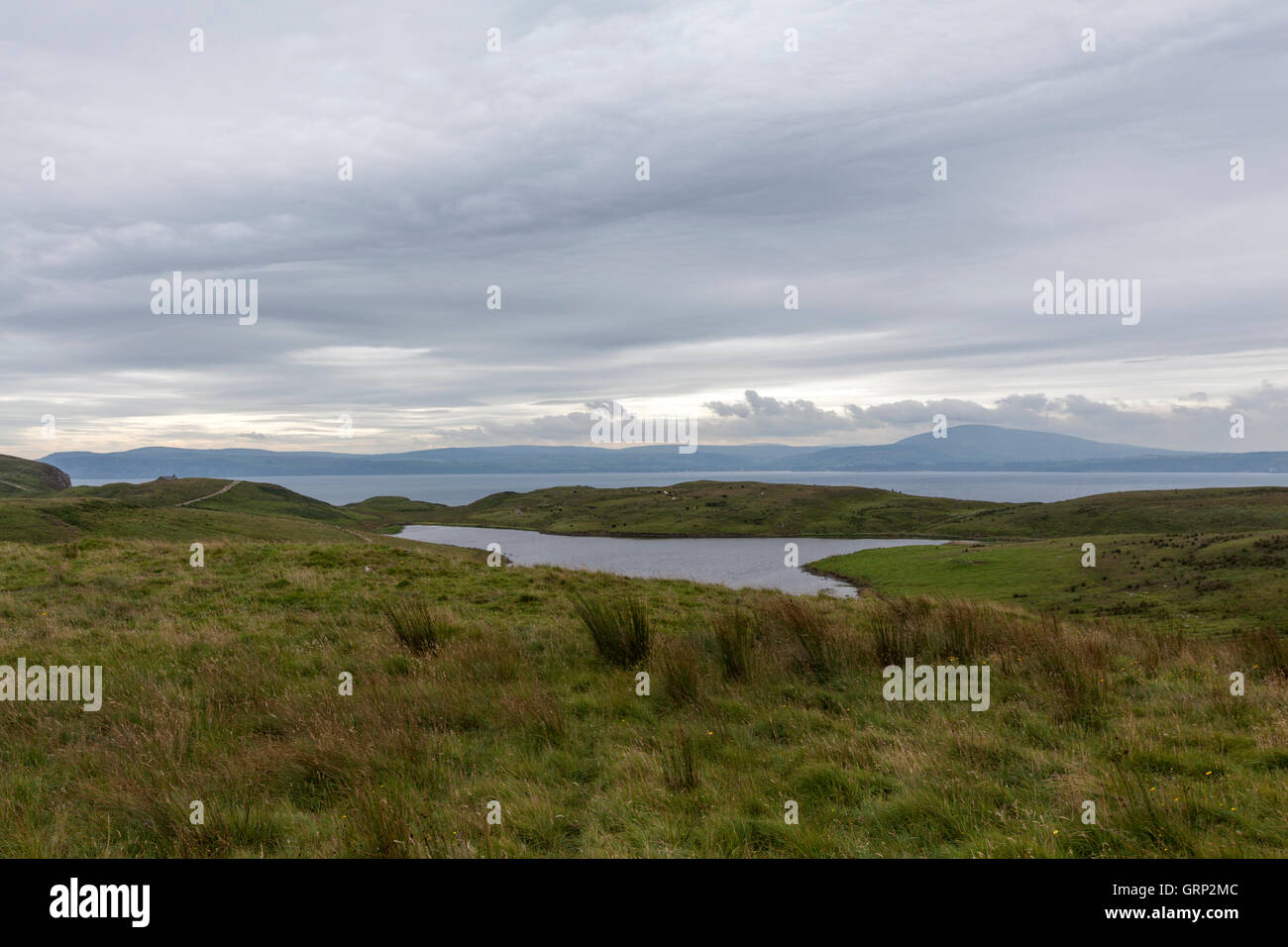 Lake near RSPB Rathlin Island with Ballycastle at the background ...