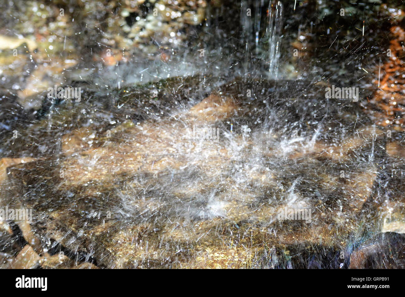 Splashing Water on Rocks Stock Photo - Alamy