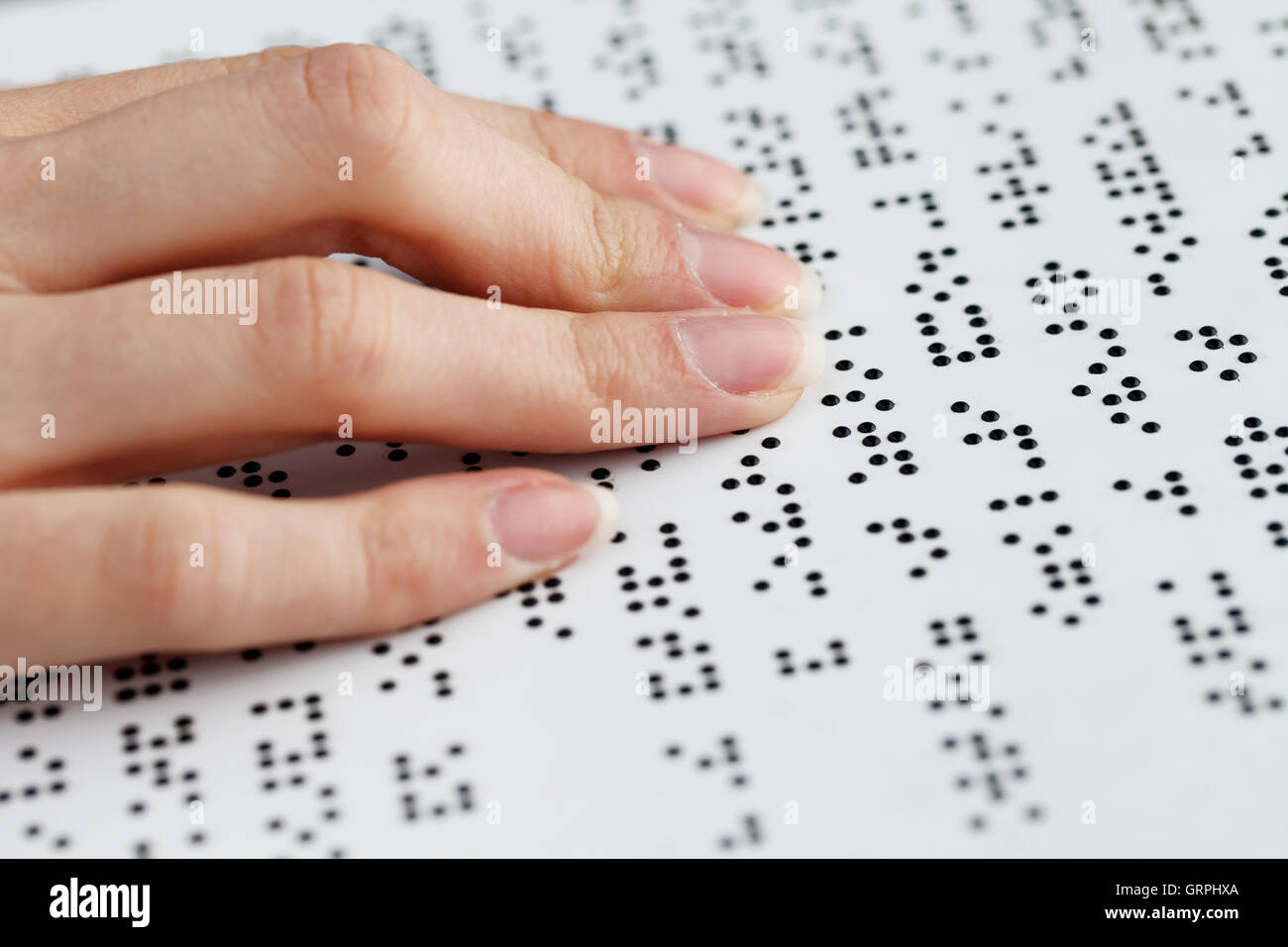 a blind reading, fingers and symbols closeup Stock Photo - Alamy