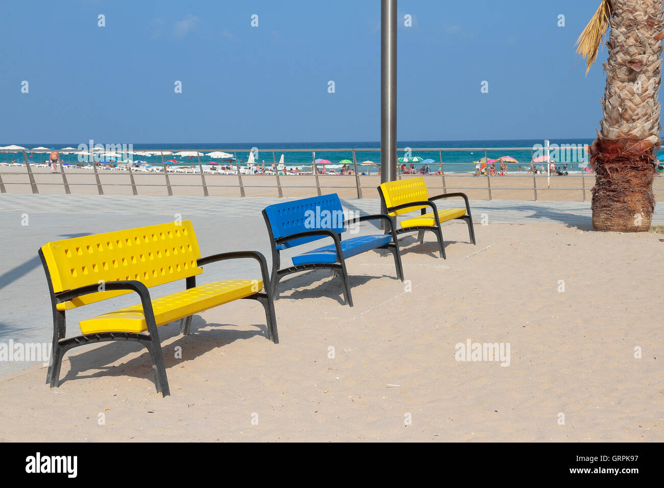 three colorful benches in a rest area on the beach Stock Photo - Alamy