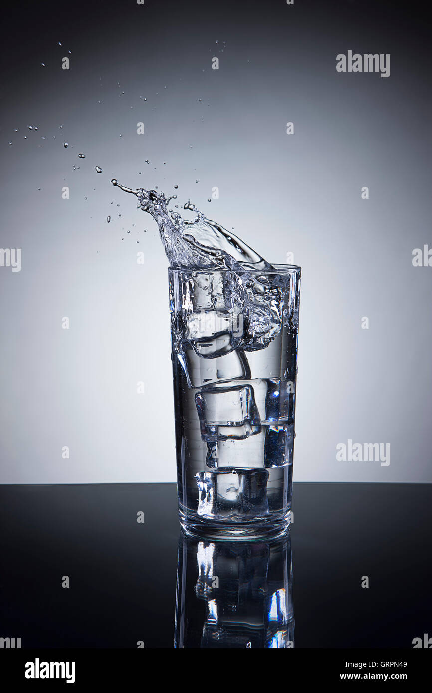 Small splash in water glass Stock Photo - Alamy