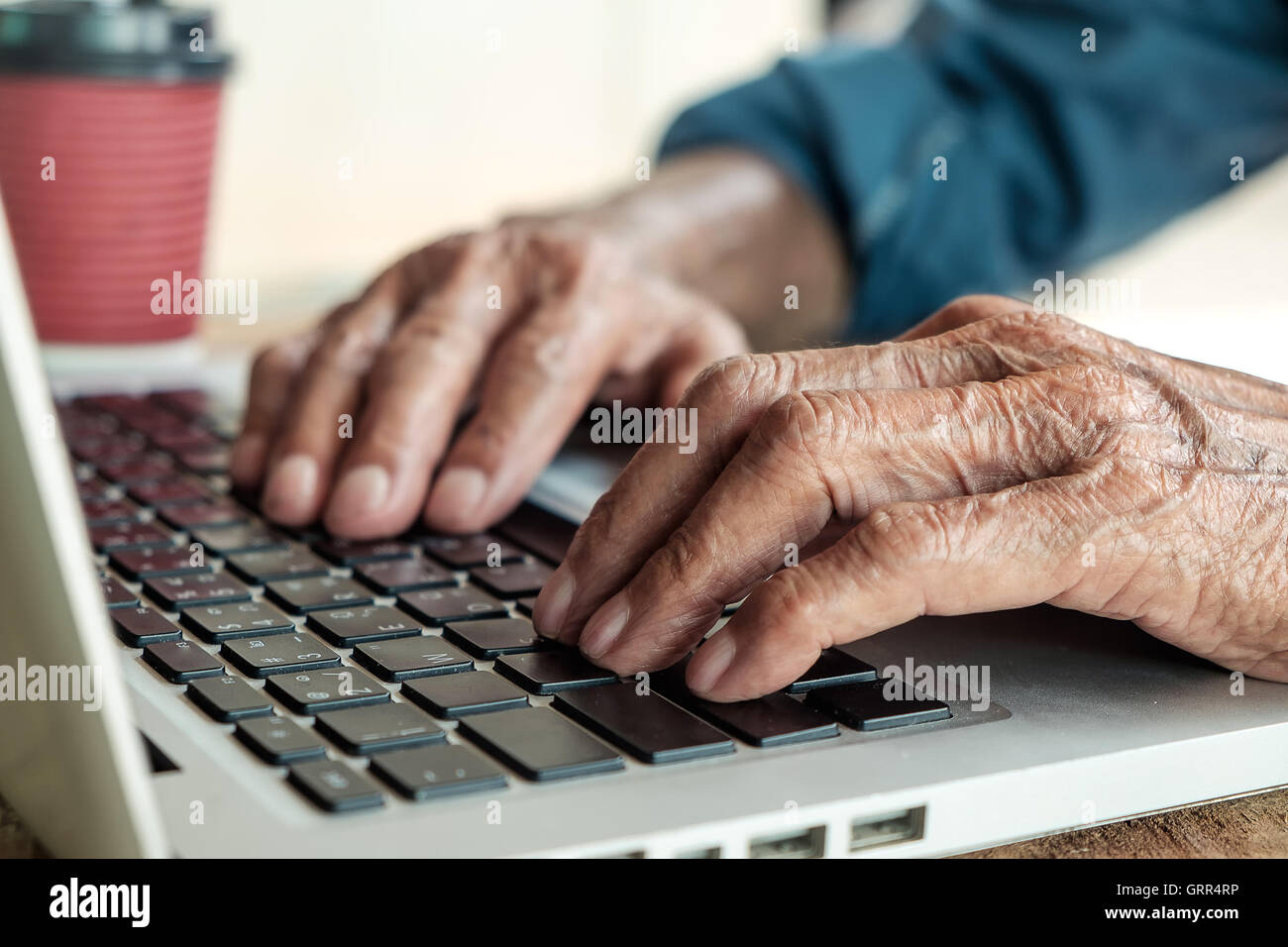 The old man typing with laptop in morning light.vintage effect Stock ...