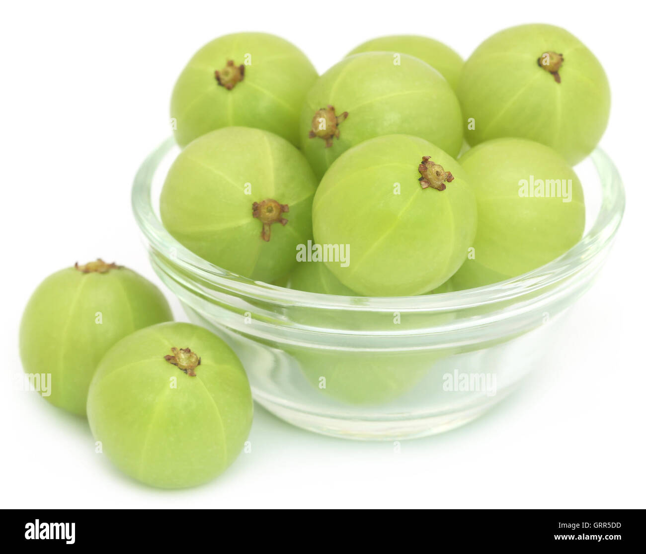 Amla fruits in a glass bowl over white background Stock Photo - Alamy
