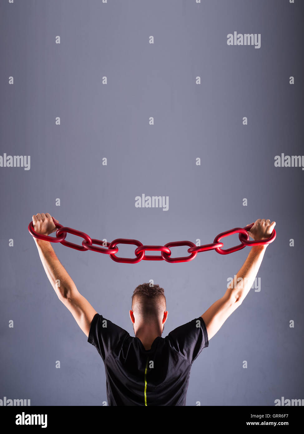 One young man in a black chain raises above his head. The concept of ...