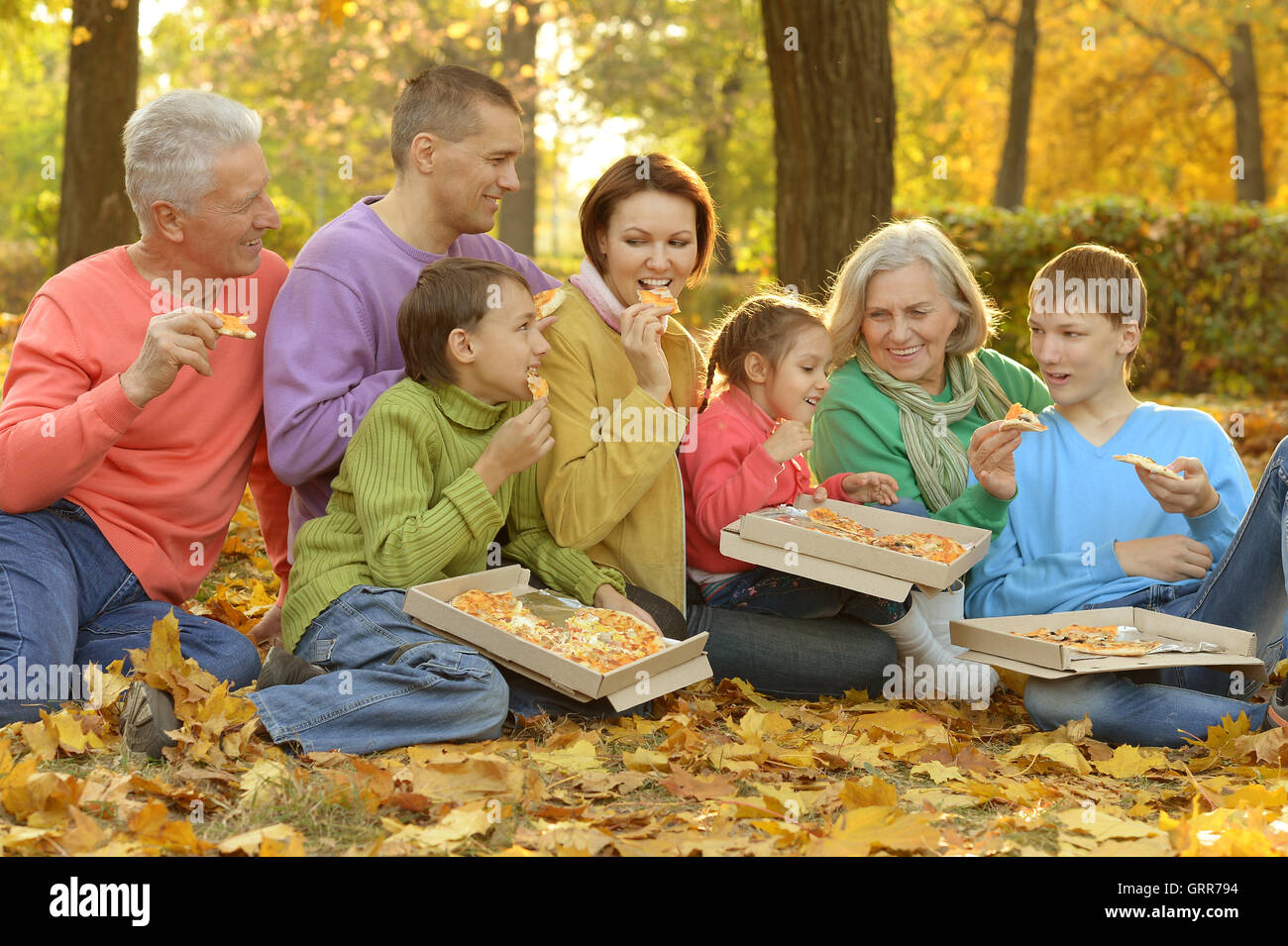Happy family eat pizza together Stock Photo - Alamy