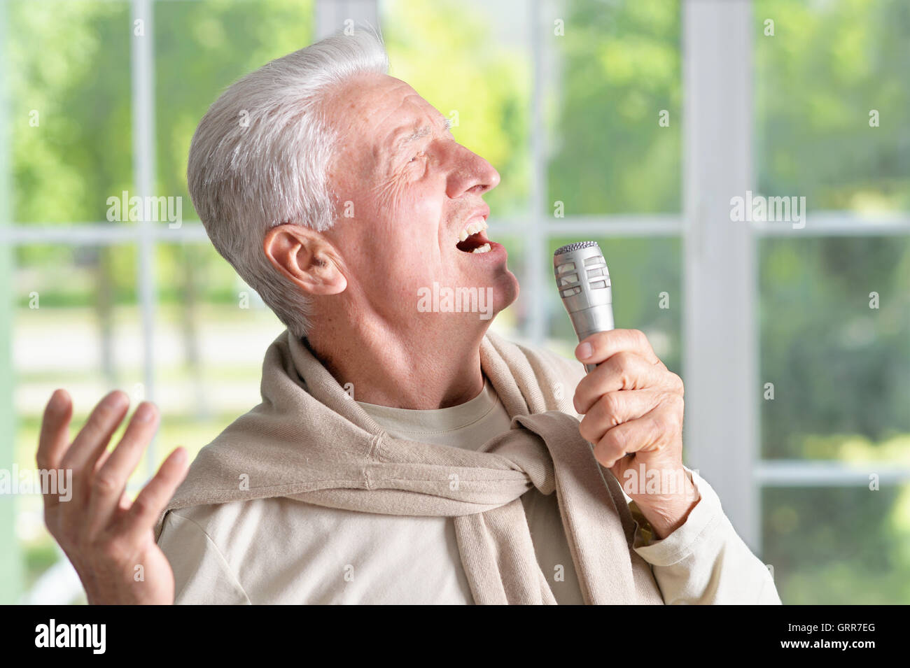 Senior man singing Stock Photo - Alamy