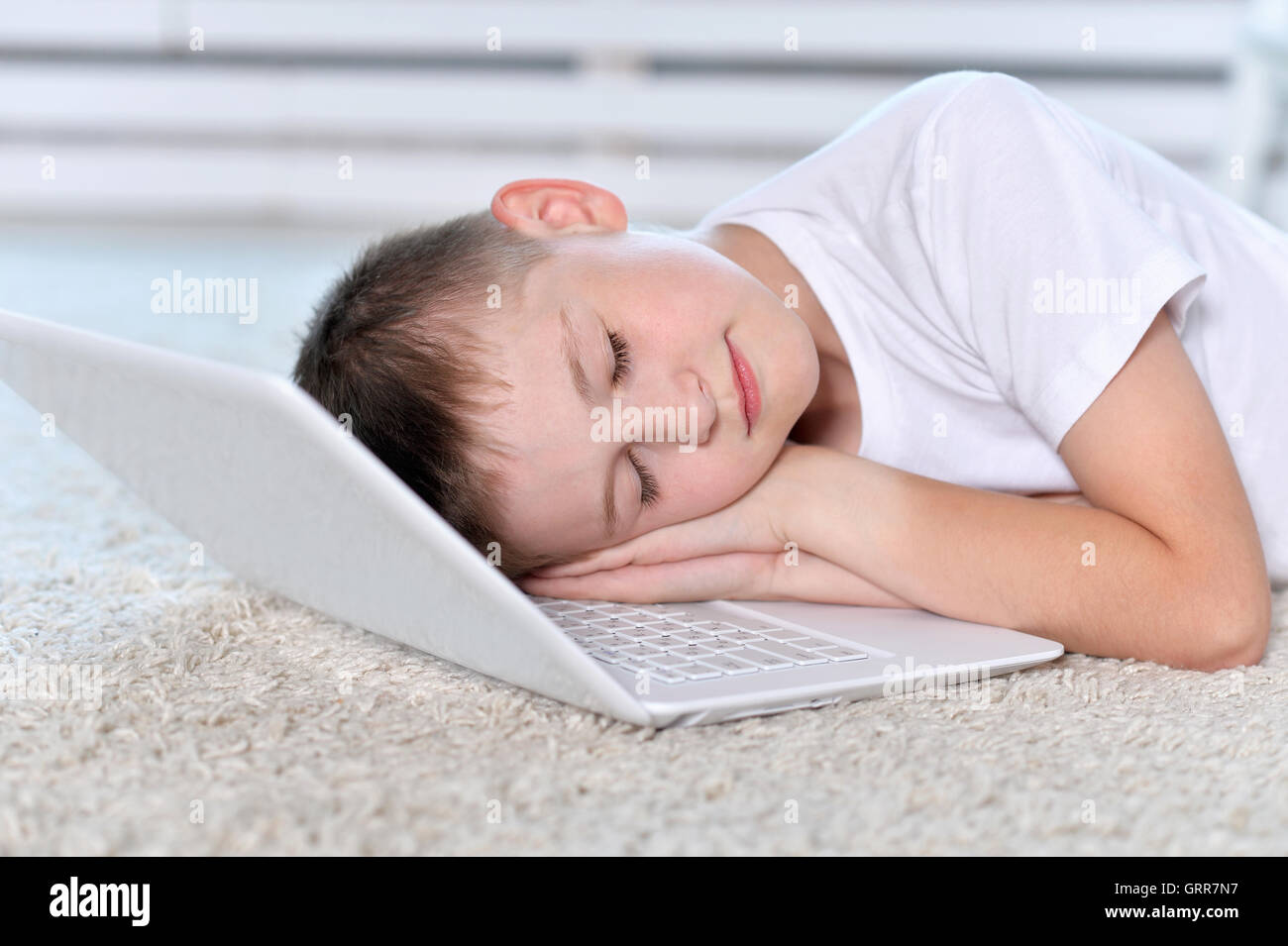 Boy sleeping near laptop hi-res stock photography and images - Alamy