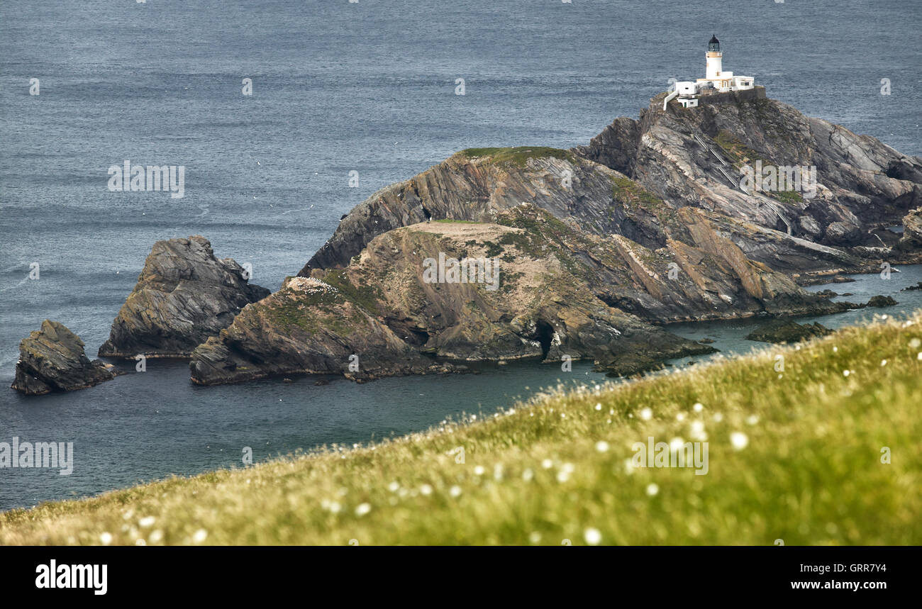 Scottish coastline landscape with lighthouse in Shetland islands ...