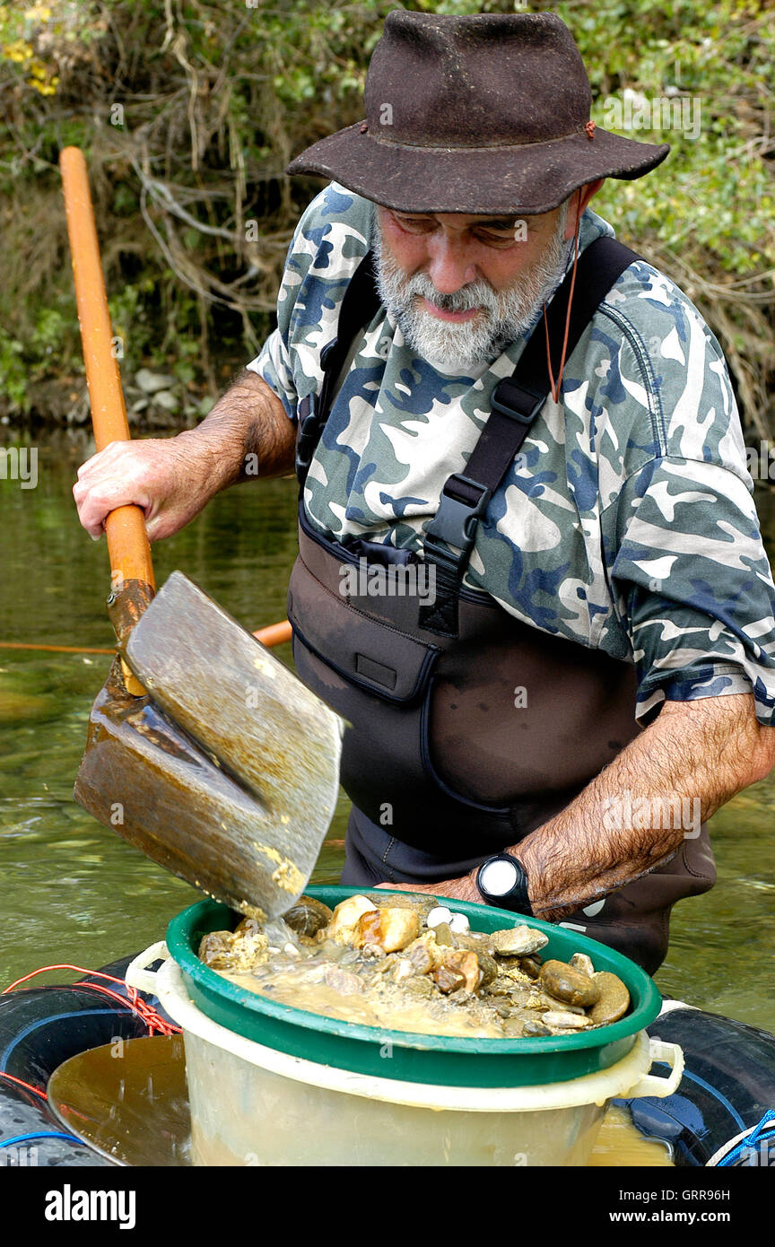 Gold digger at work in France in the river Gardon in the Gard ...
