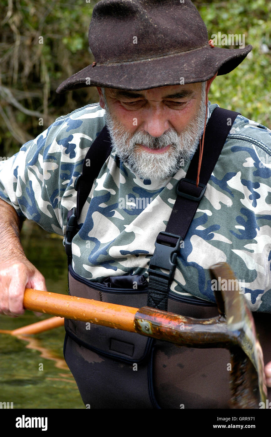 Gold digger at work in France in the river Gardon in the Gard ...