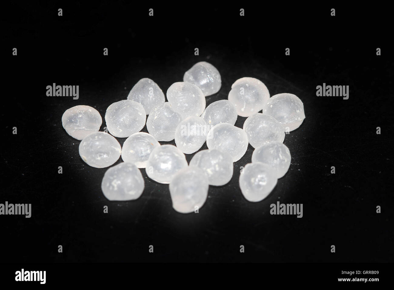 Translucent plastic granules used for injection molding isolated on ...