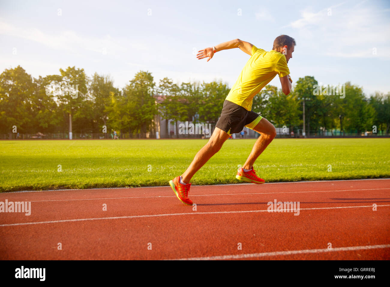 runner runs stadium summer on racetrack Stock Photo - Alamy