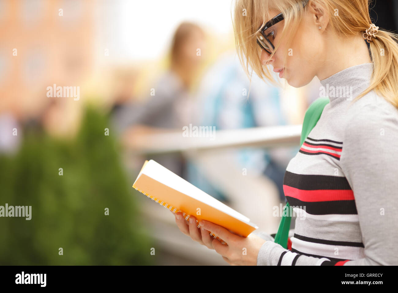 cute girl with Notepad in hands on street Stock Photo - Alamy