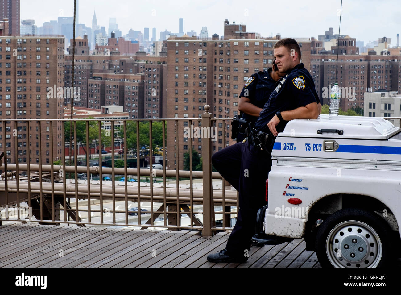 A New York Policeman leans on the back of his vehicle on the Brooklyn ...