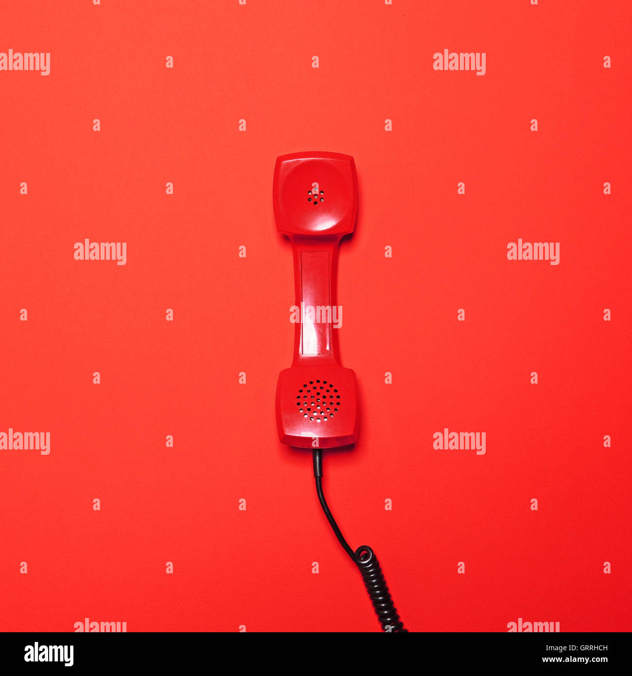 Retro red telephone tube on red background - Flat lay Stock Photo - Alamy
