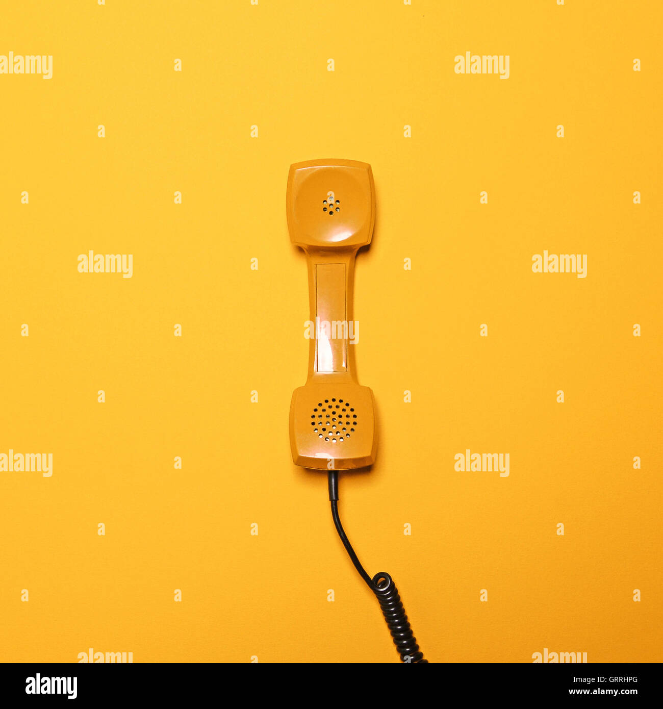 Retro yellow telephone tube on yellow background - Flat lay Stock Photo ...