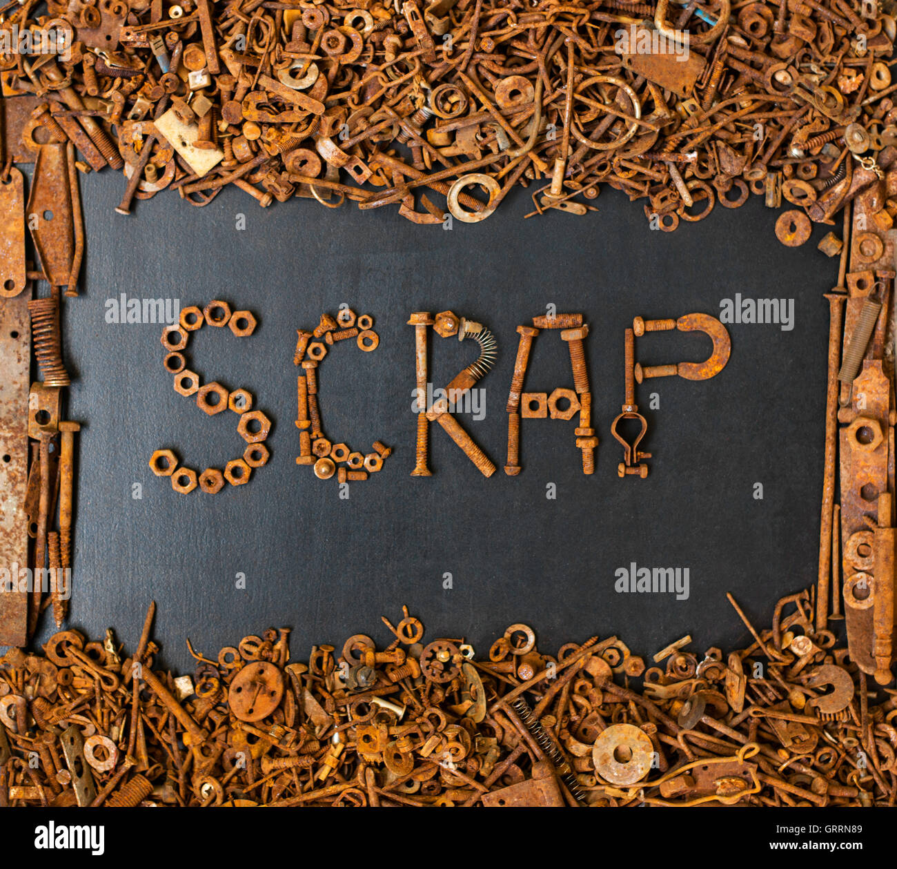 SCRAP made with rusty screws and bolts on black board with frame ...