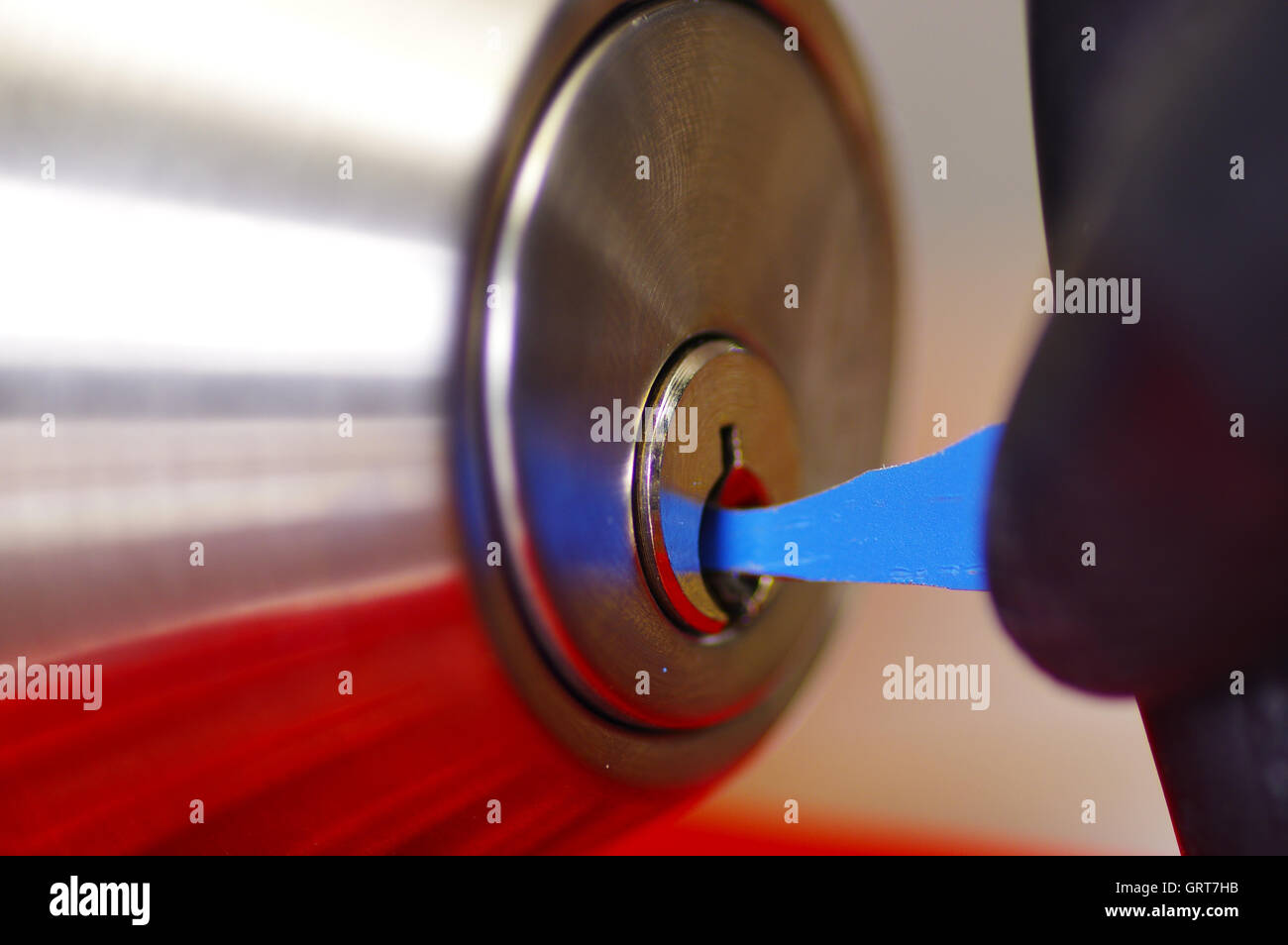 Closeup hands of locksmith using metal pick tools to open locked door ...