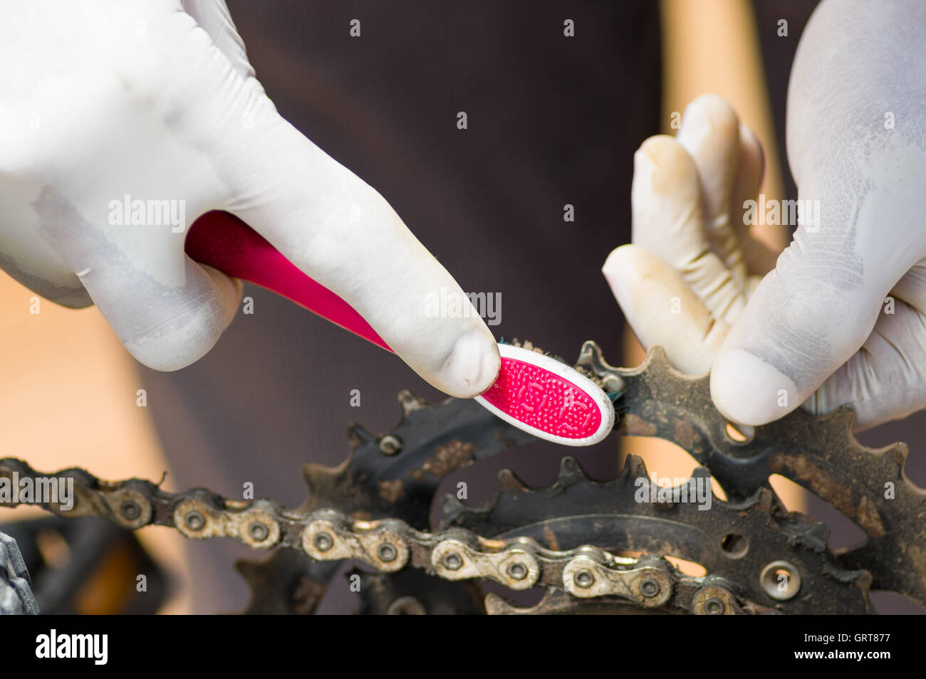 Closeup hand wearing white glove holding toothbrush rubbing on metal ...