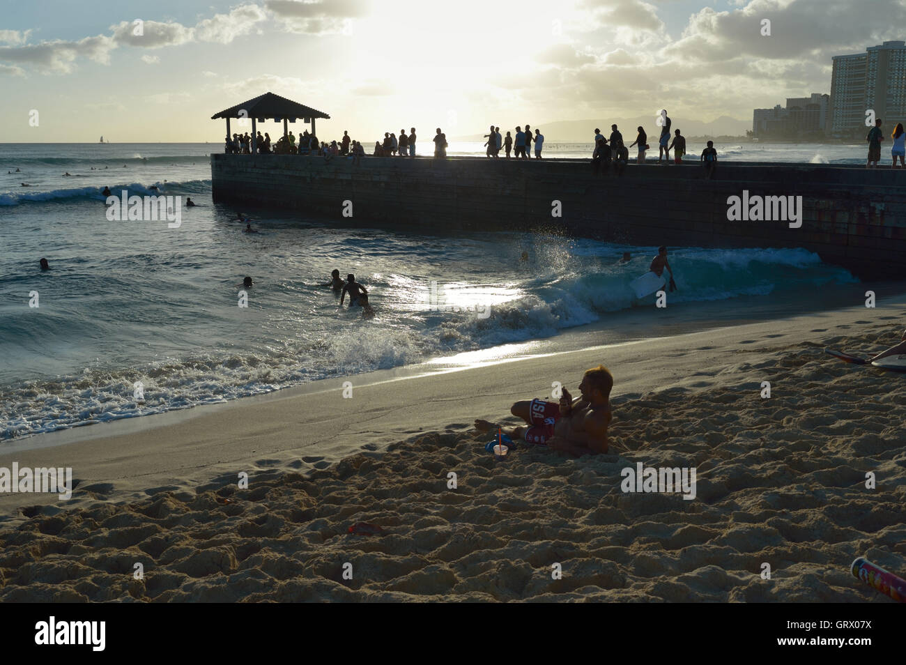 Water activities during sunset at Waikiki beach, Honolulu HI Stock ...