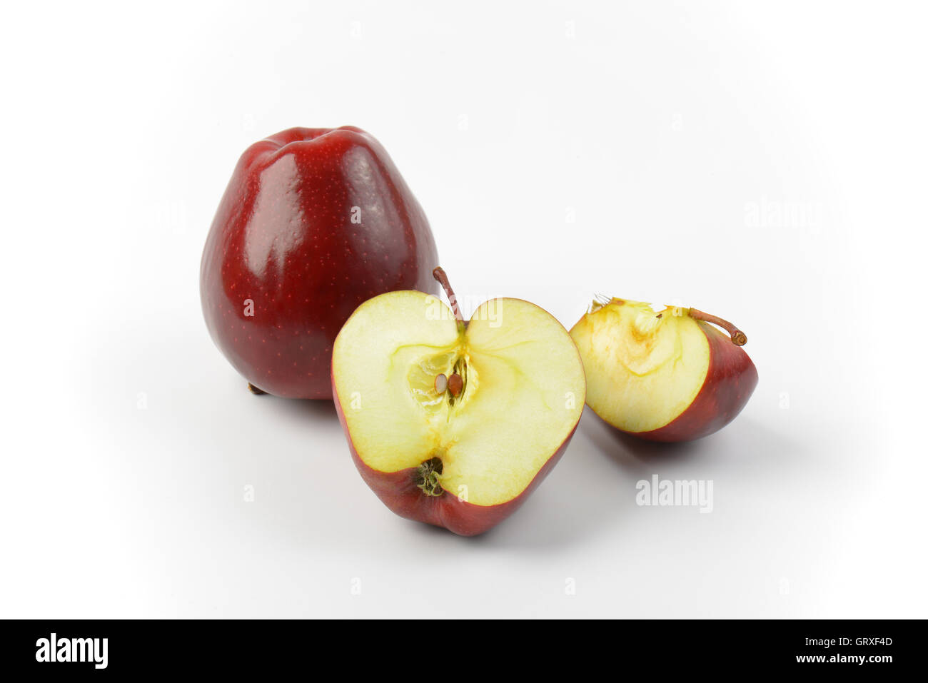 one whole red apple, one half and slice Stock Photo - Alamy