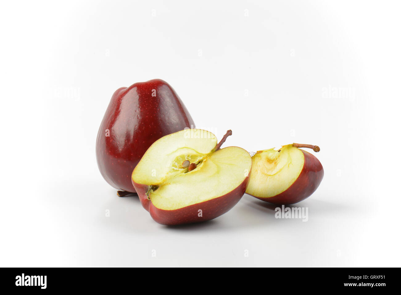 one whole red apple, one half and slice Stock Photo - Alamy