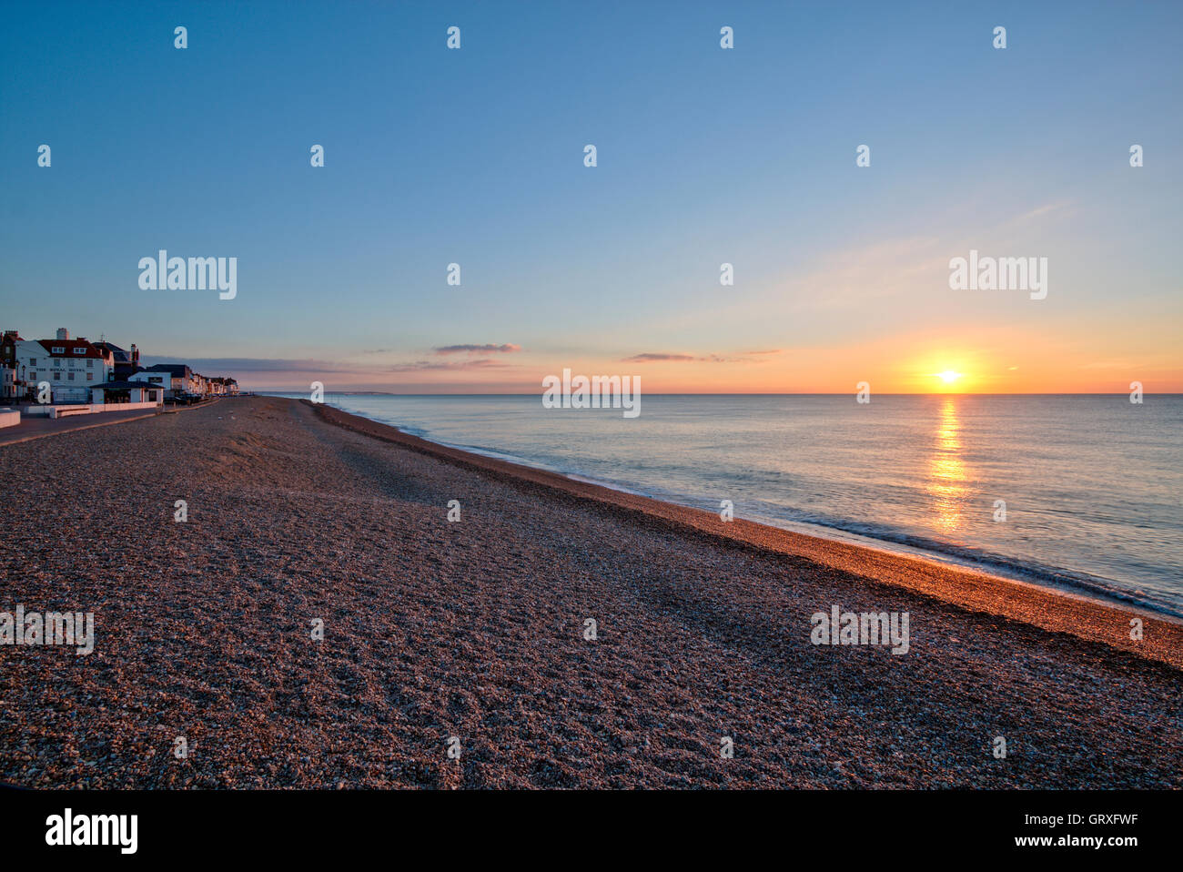 View along shingle beach at the Kent coastal town of Deal. Town on left ...