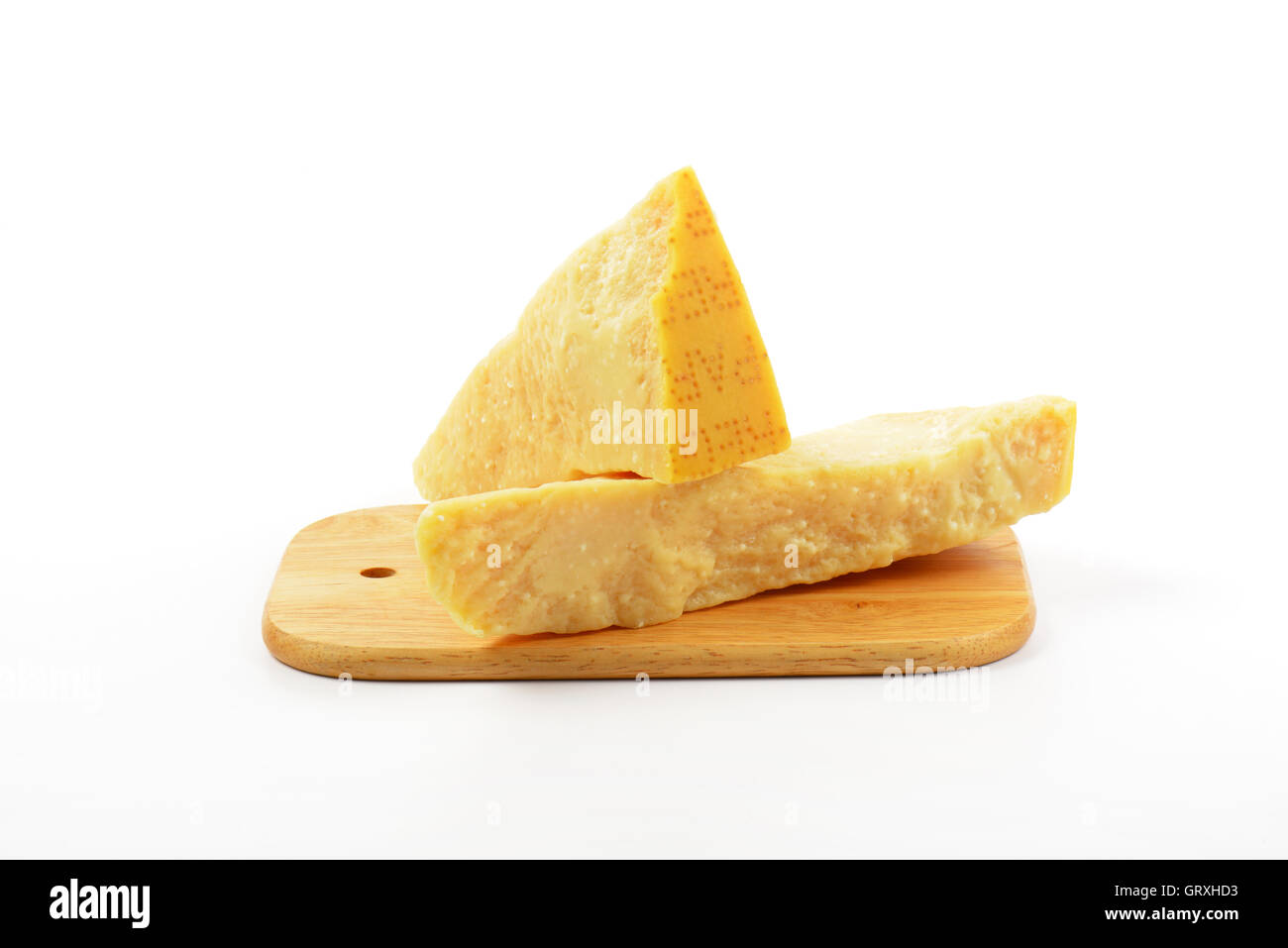 Pieces of true Parmesan cheese on cutting board Stock Photo - Alamy