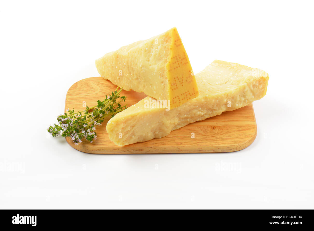 Pieces of true Parmesan cheese on cutting board Stock Photo - Alamy