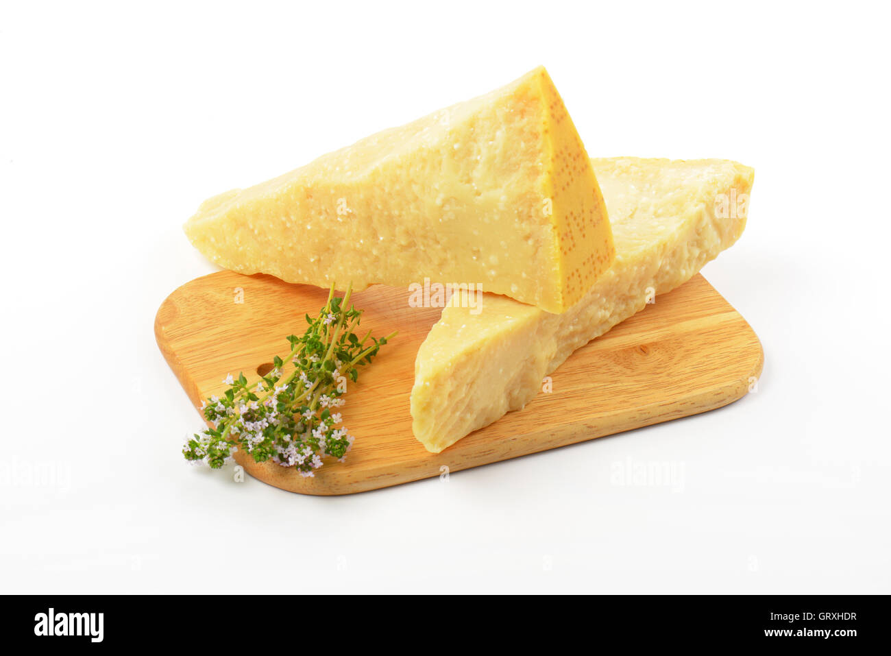Pieces of true Parmesan cheese on cutting board Stock Photo - Alamy