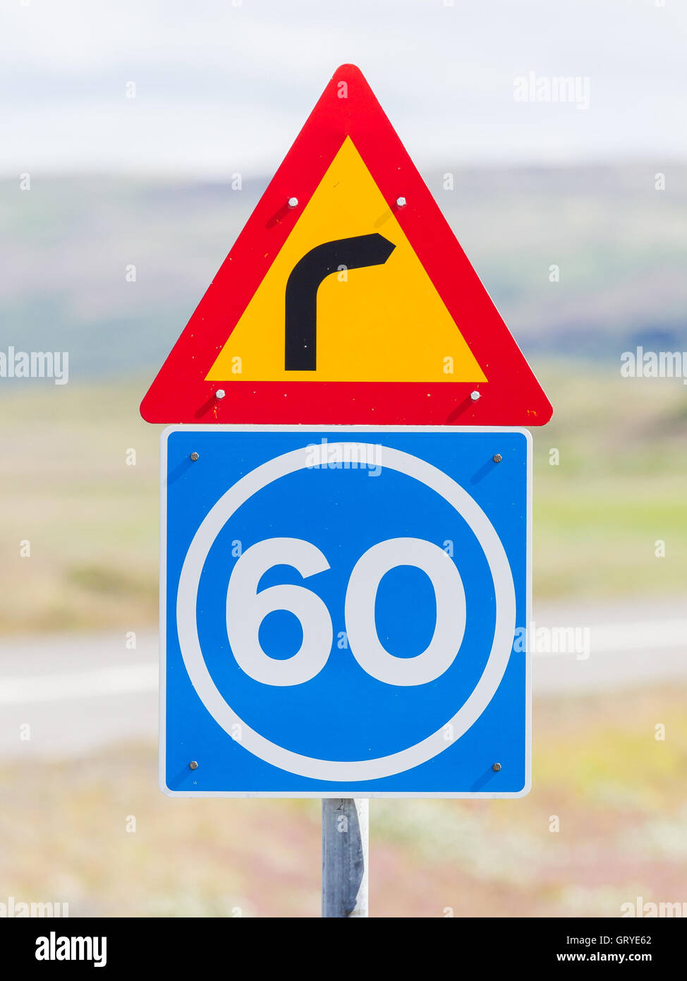 Curve with advisory speed limit in Iceland Stock Photo - Alamy