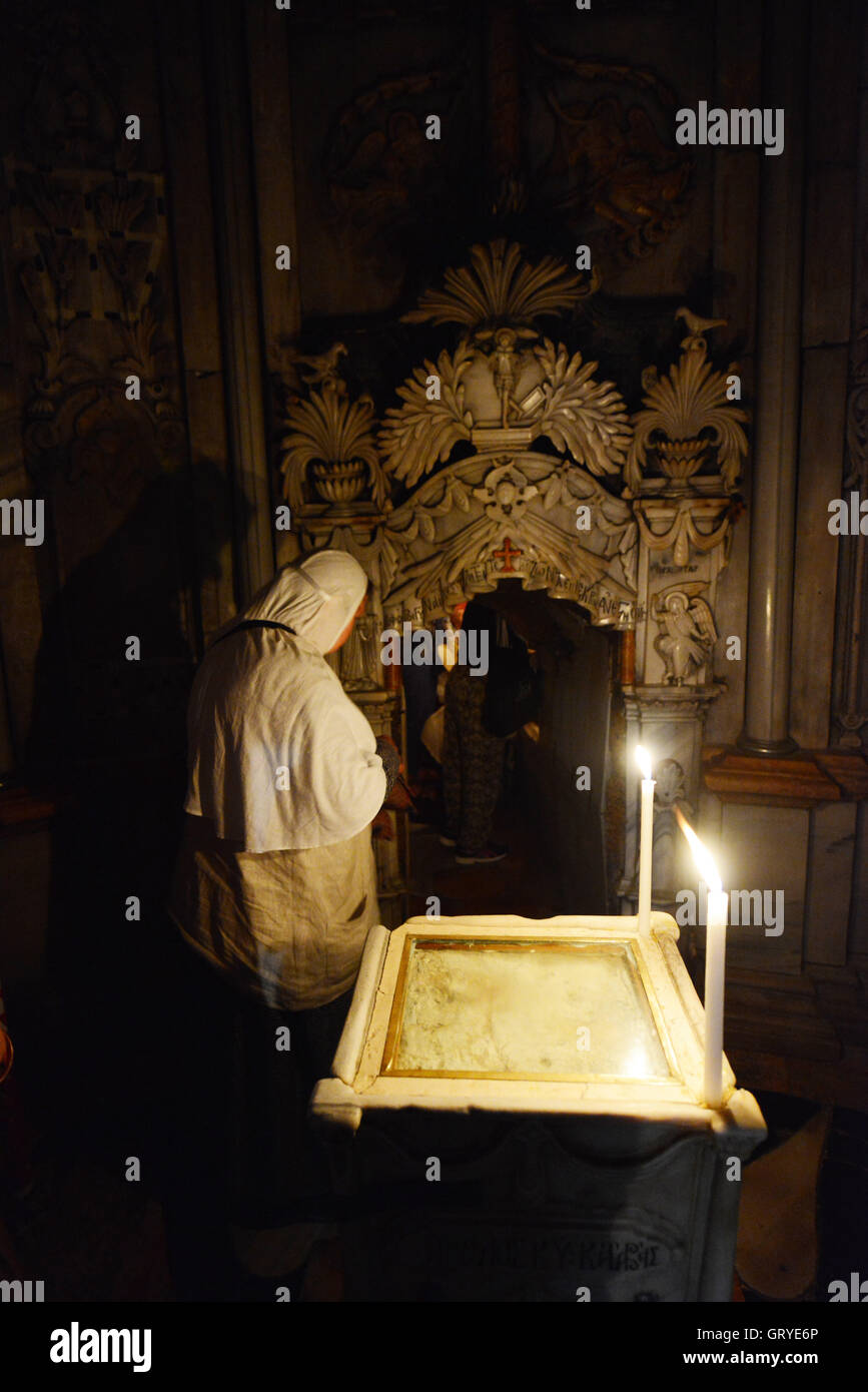 A nun waiting to go into the chamber of the of Sepulchre inside the ...