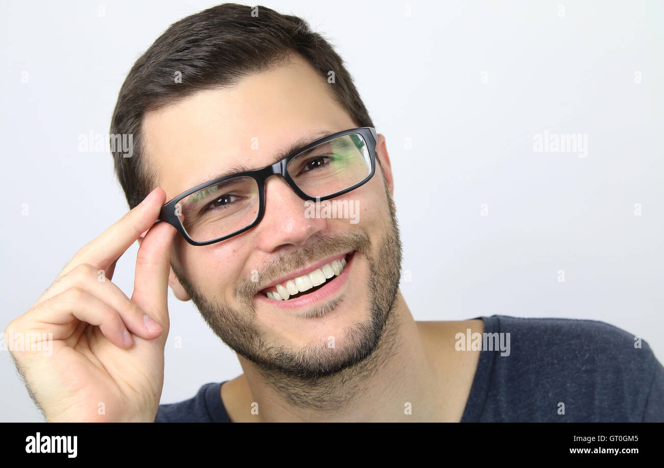 Handsome man holding glasses smiling Stock Photo - Alamy