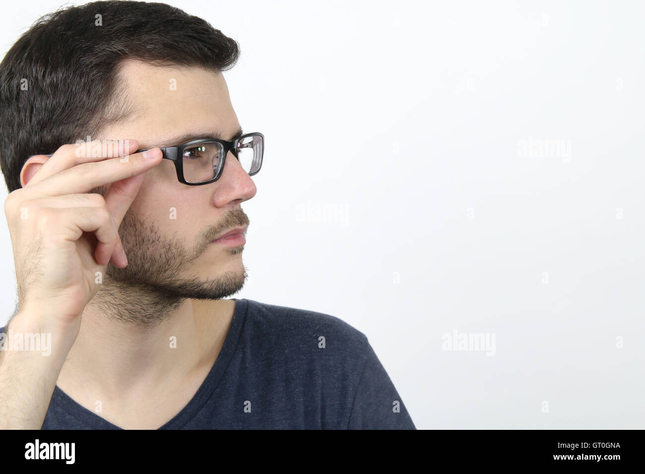 Handsome man holding his glasses Stock Photo - Alamy