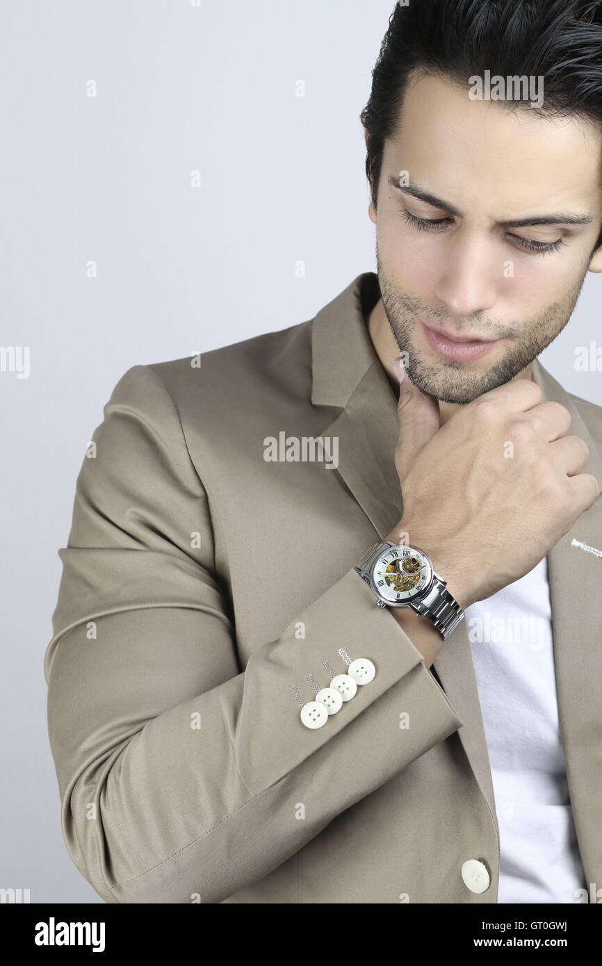 Handsome man showing his watch Stock Photo - Alamy