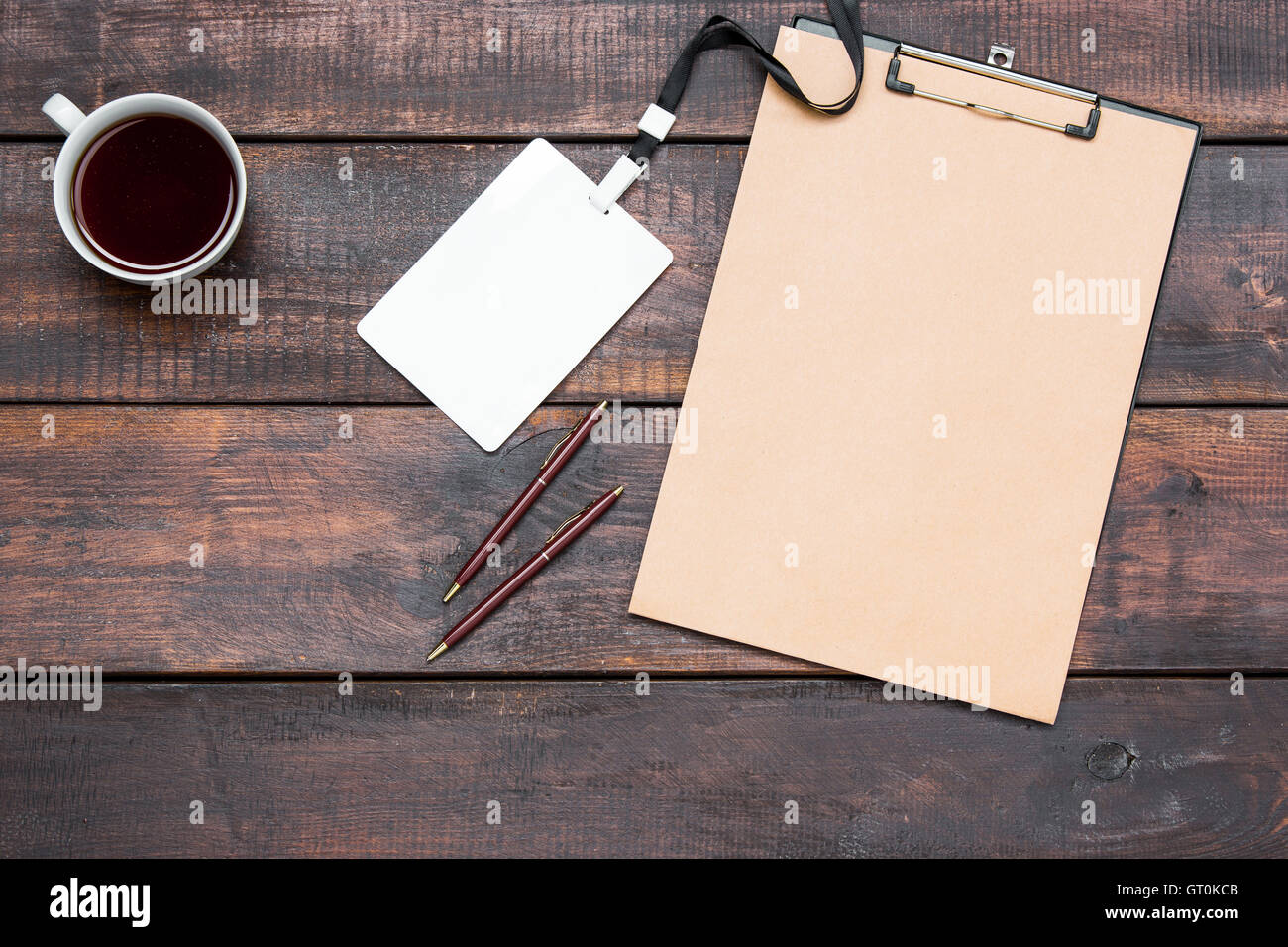 Office wooden table with pens, tablet for notes and cup Stock Photo - Alamy
