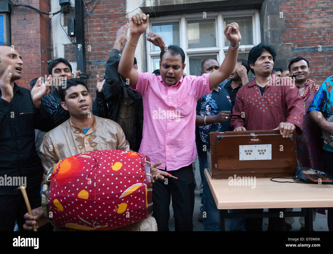 Bengali musicians playing and sining on a street, Brick Lane, London ...