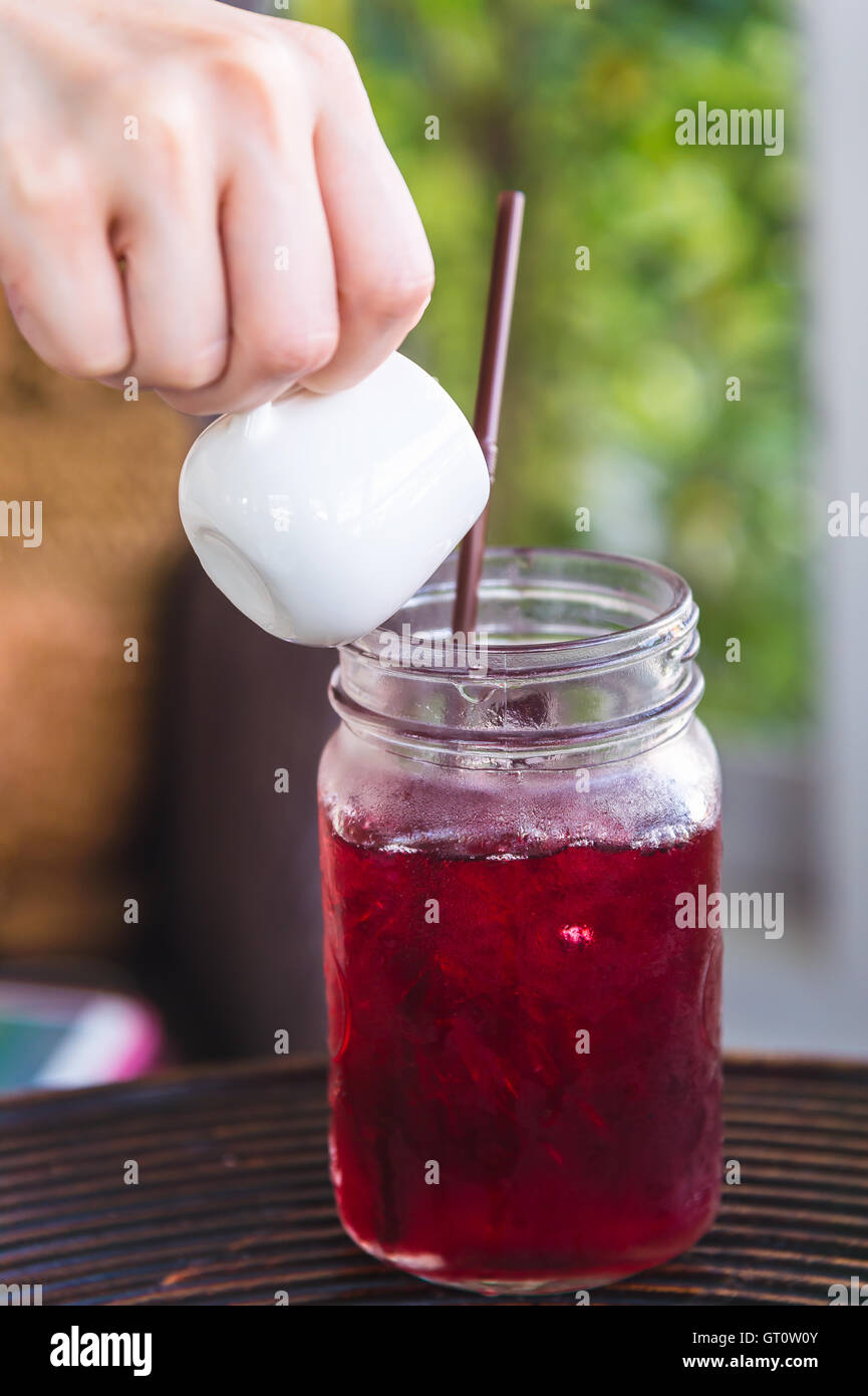 hand pouring syrup in berry juice jar Stock Photo - Alamy