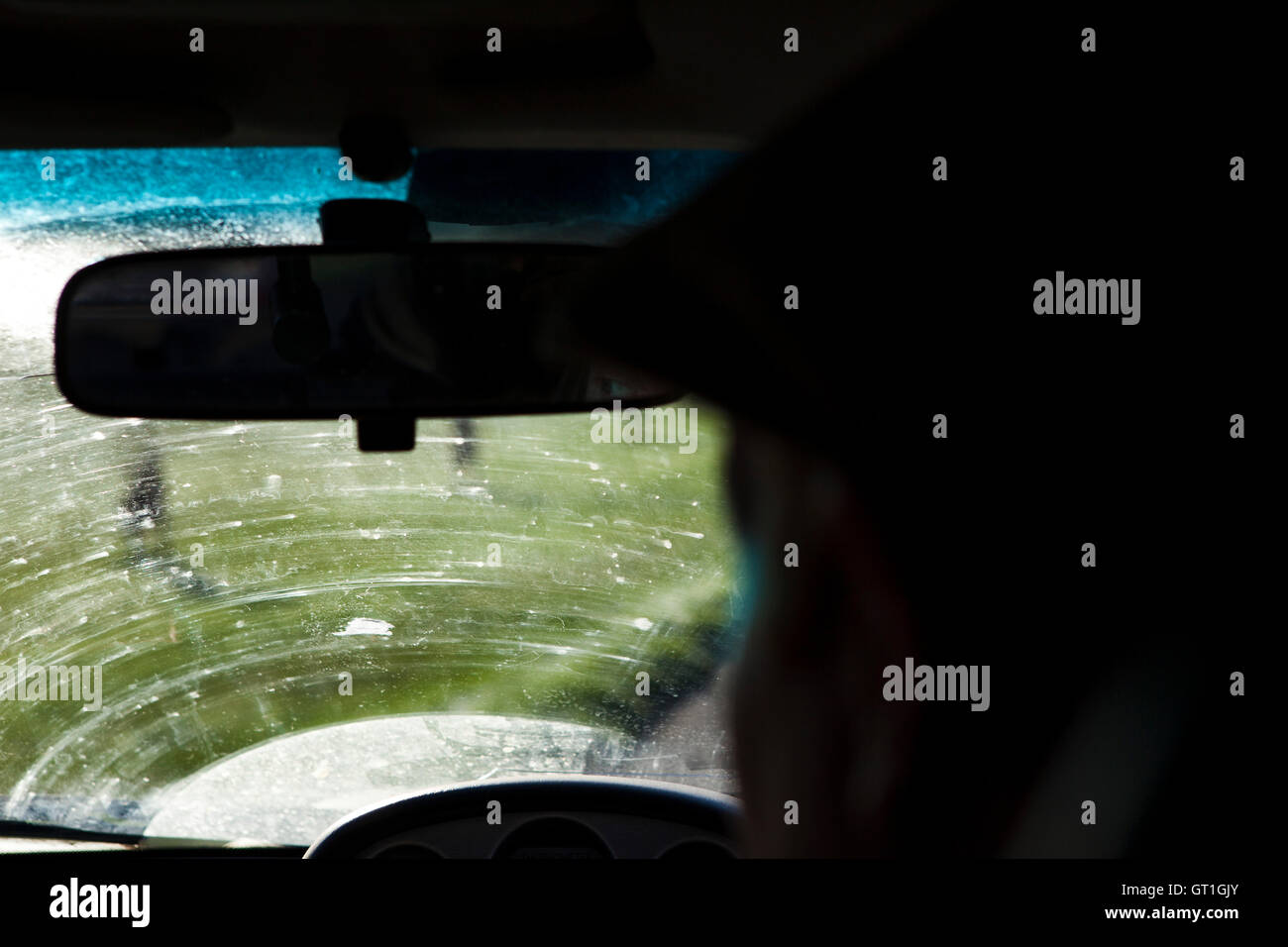 Looking through a very dirty car windscreen coverd in mud smears Stock ...