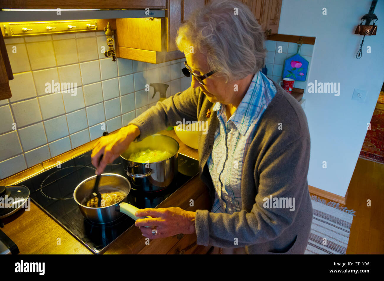 Woman cooking kitchen pots hi-res stock photography and images - Alamy