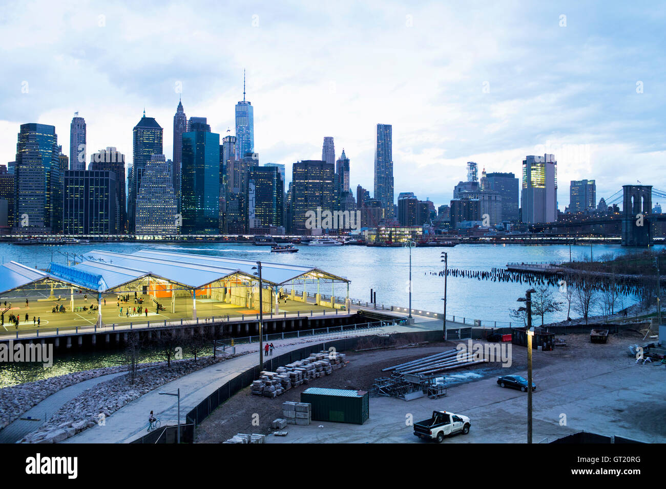 Basketball court by commercial dock against East River during stormy ...
