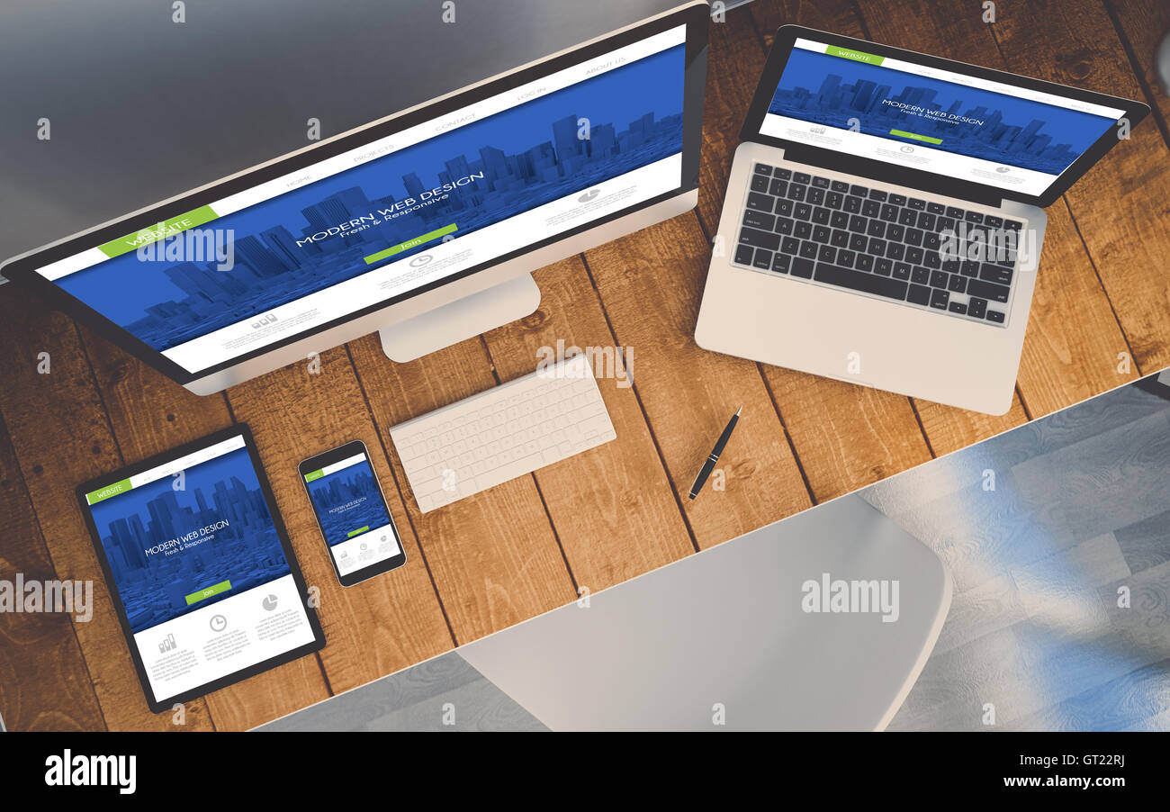 top view of a computer, laptop, smartphone and tablet on a desktop ...