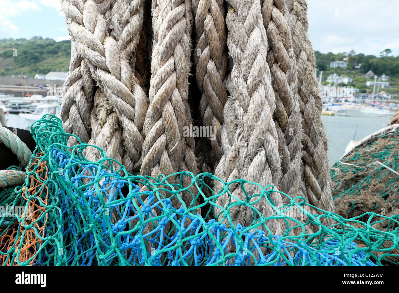 Plaited rope and blue and green fishing nets at the harbour by the Cobb ...