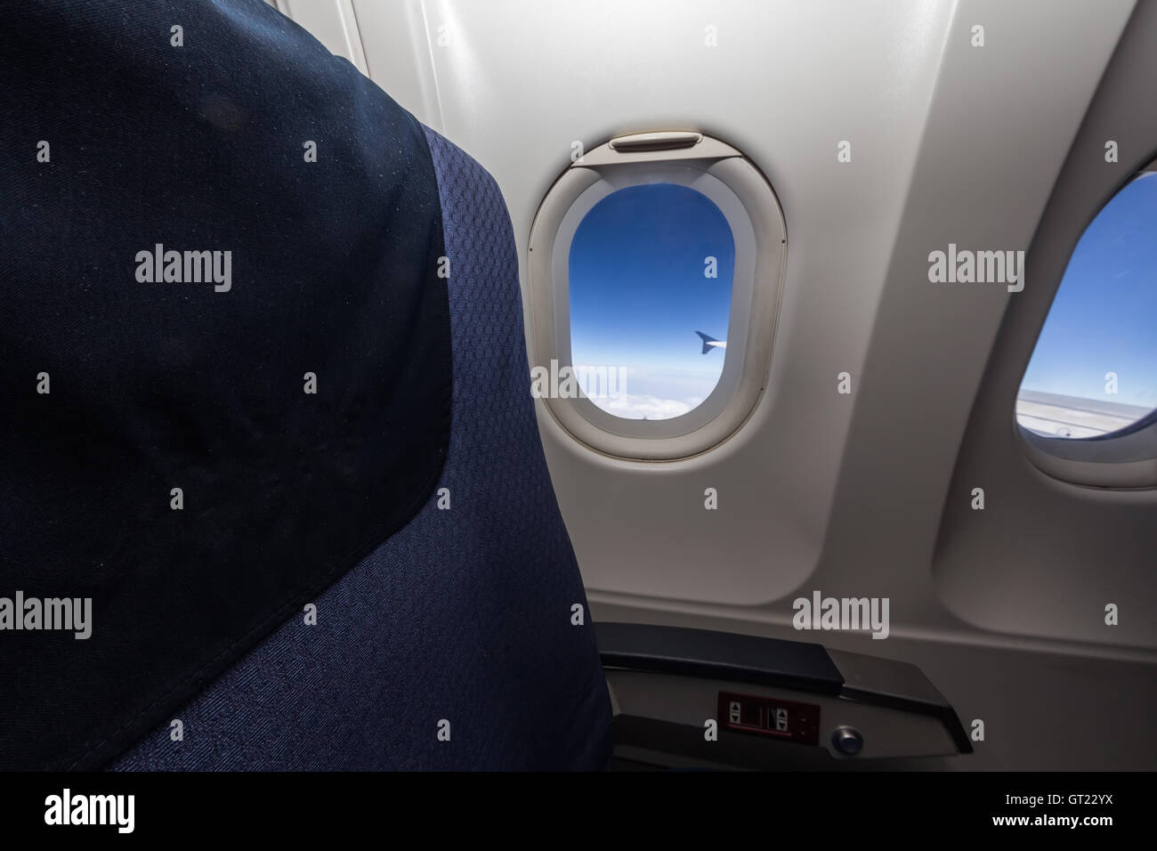 Airplane seat and window inside an aircraft. Image with shallow depth ...